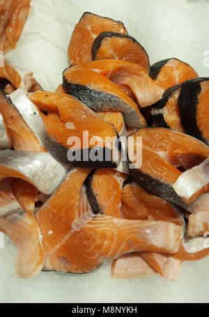 Meat and fish pieces in ice cubes falling against white background ...