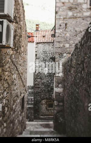 Empty alley amidst old buildings against sky during sunny day Stock ...