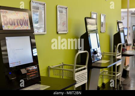 Borrow sign and borrowing booths at a library, CityLibraries Aitkenvale ...