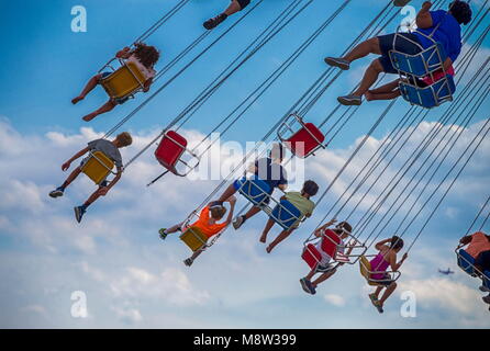 Visitors ride the carousel chair swing ride during the Wisconsin State ...