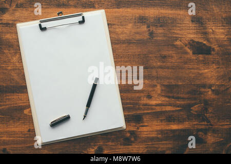 Blank to do list, clipboard and pen on wooden background, closeup Stock ...