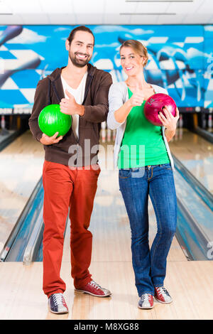 Friends playing Bowling at bowling center Stock Photo - Alamy