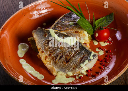 Grilled dorada fillet served tomato and onion Stock Photo - Alamy