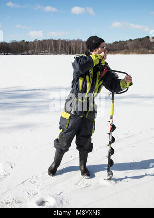 frozen lake drilling hole through ice for fishing norway arctic winter ...