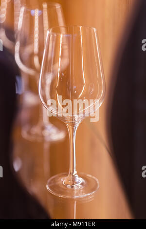 A closeup of a row of glasses on a wooden table Stock Photo - Alamy