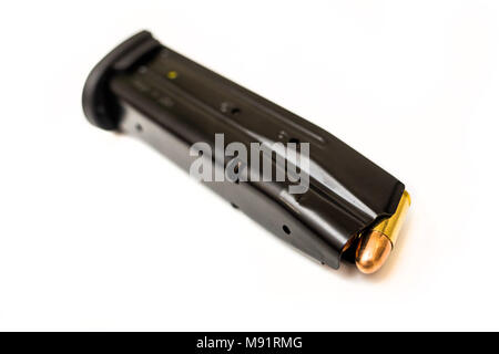Loaded handgun magazine on white surface isolated Stock Photo - Alamy