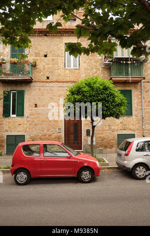 Green small house with parked retro car near tropical trees and ...