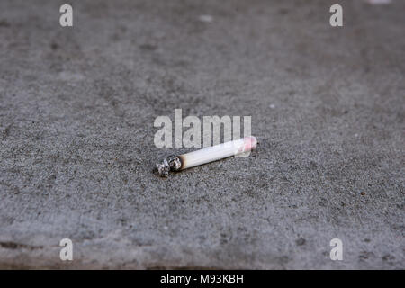 cigarette butt lying on the street Stock Photo - Alamy