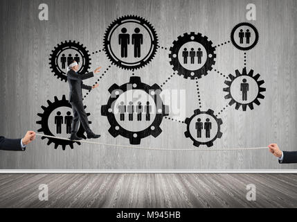 Businessman with blindfolder on eyes walking on rope Stock Photo - Alamy