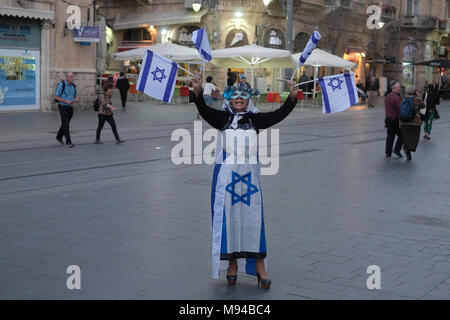 A Jewish woman wrapped with the Israeli flag dancing and singing ...
