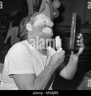 Otto Griebling prepares applies his nose and make-up before a ...