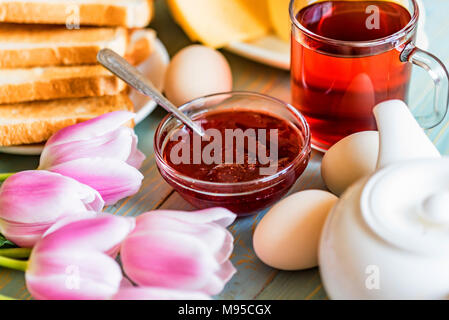 Delicious toast with jam and cup of tea on table close-up Stock Photo ...