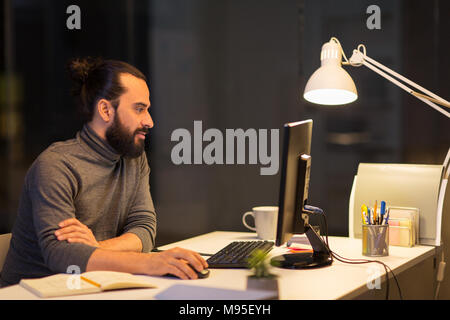 creative man with computer working at night office Stock Photo - Alamy