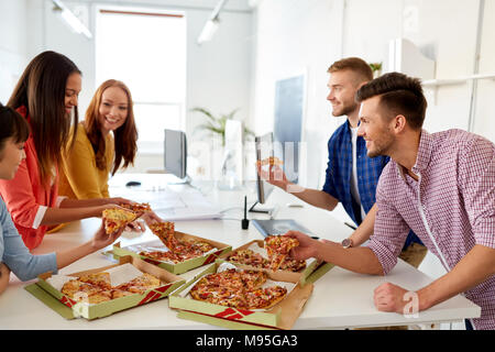 happy business team eating pizza in office Stock Photo - Alamy