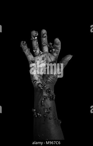 Zombie hand rising from the ground on black background. Halloween ...