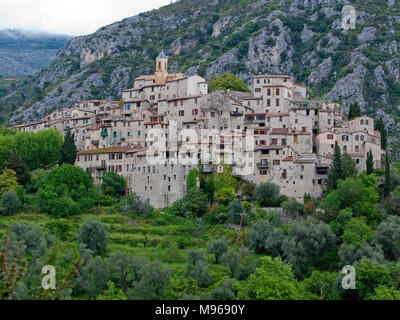 The fortified medieval village Peillon clings to a cliff face ...