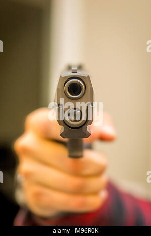 Young woman at home pointing with hand and finger up with happy face ...