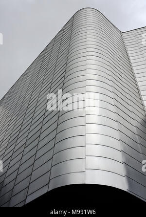 Sunlight reflecting off curved aluminium rainscreen cladding on corner ...