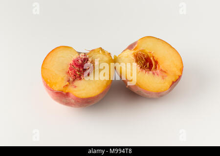 Fresh dissected peach with stone on white background Stock Photo - Alamy