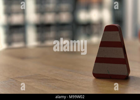Toy caution wooden traffic pylon, warning conus Stock Photo - Alamy