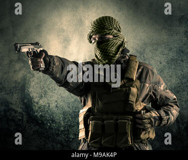 Portrait of a heavily armed masked soldier with grungy background ...