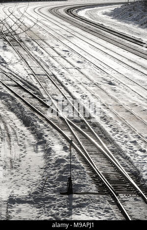 Railroad switch with train in the winter. Old Railway arrow in a winter ...