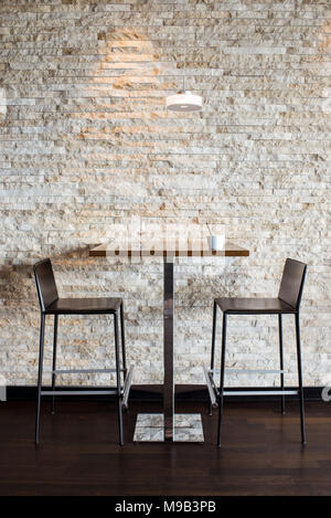 Design Interior a café table and chairs with stone floors and plant ...