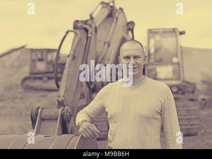 Portrait of tractor operator at sand pit Stock Photo - Alamy