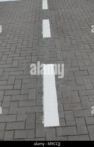 White stripes on grey asphalt, concrete marking Stock Photo - Alamy