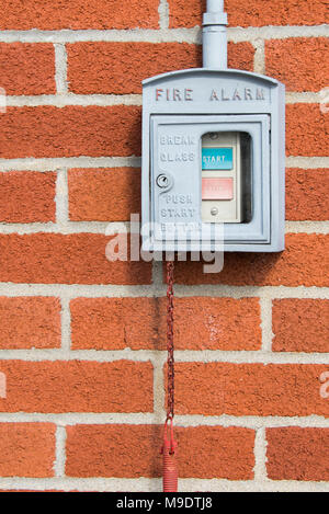 wall mounted Red fire alarm button used to activate warning systems in ...