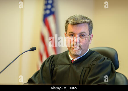 Angry male judge in a courtroom striking the gavel and pronounces ...