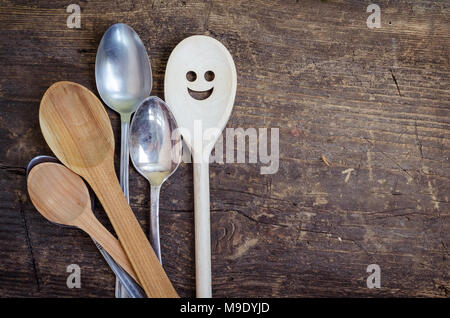 One spoon with smiley face standing out from the crowd - individuality ...