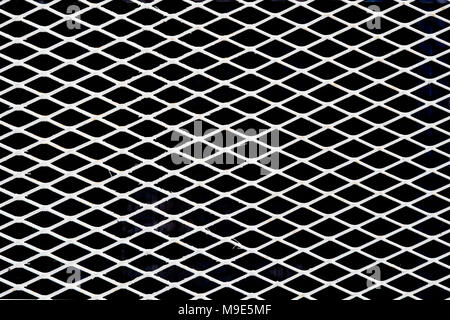 Diagonal white metal wire grid or mesh, black background. Black and ...