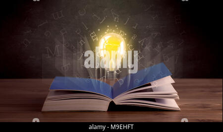 Shiny alphabet letters and yellow lightbulb hovering over open book ...