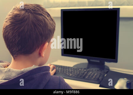 Junior schoolboy using Pc Stock Photo - Alamy