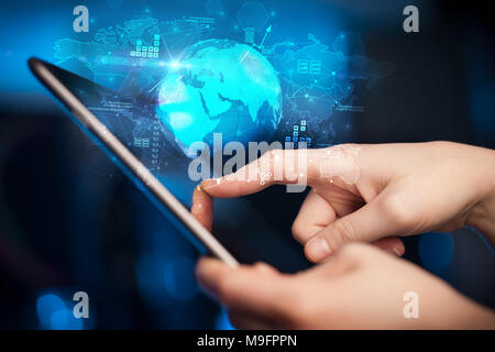 Hand using tablet with multinational worldwide estate report concept ...