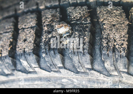 Deflated damaged tyre on white car wheel Stock Photo - Alamy
