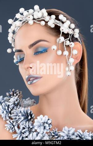 tender woman with hair accessory, christmas pine cones, winter makeup ...