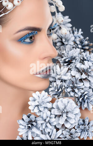 tender woman with hair accessory, christmas pine cones, winter makeup ...