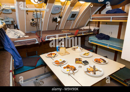 Inside accommodation cabin / room with mess table, seats, bunks, etc ...