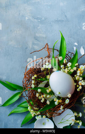 White gypsophila flowers with green leaves on vintage wooden background ...