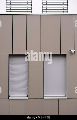 A modern office building facade with sheet metal cladding and an ...