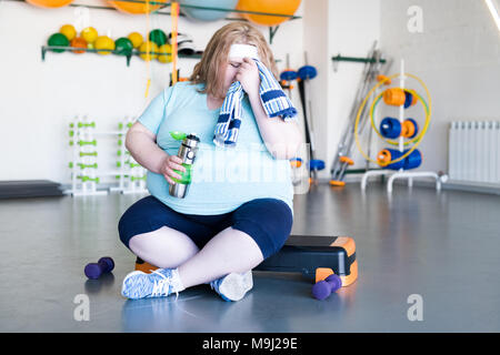 Woman losing weight is exhausted after exercise Stock Photo - Alamy