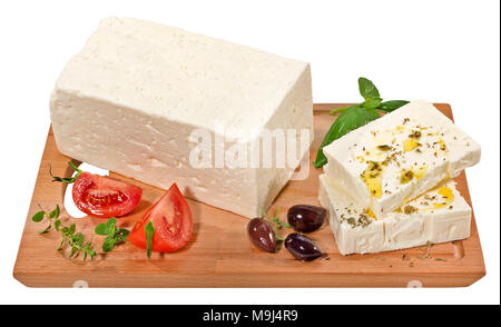 Feta cheese slice on the board with herbs Stock Photo - Alamy