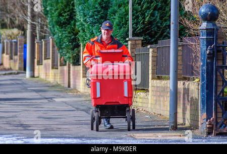 Royal Mail postal worker pushing a mail trolley in Southend on Sea ...