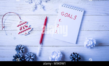 Workplace with a diary, decorations and gifts. New Year's list o Stock ...