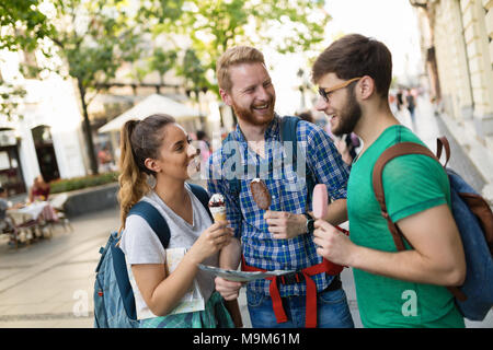 Tourist friends discovering city on foot Stock Photo - Alamy