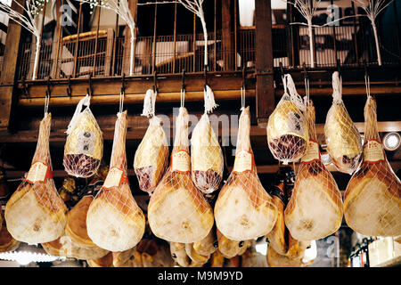 Italian ham or prosciutto hanging in meat shop in Rimini Stock Photo ...