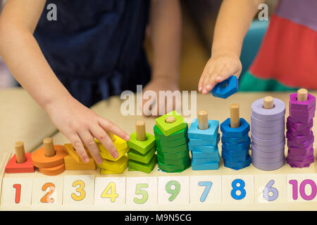 children stacking colorful wooden shapes Stock Photo - Alamy