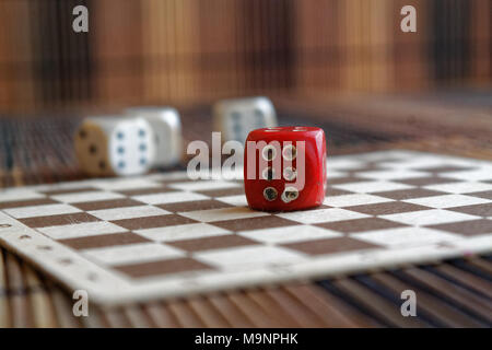 Red dice with two-dot side facing the camera, close up Stock Photo - Alamy